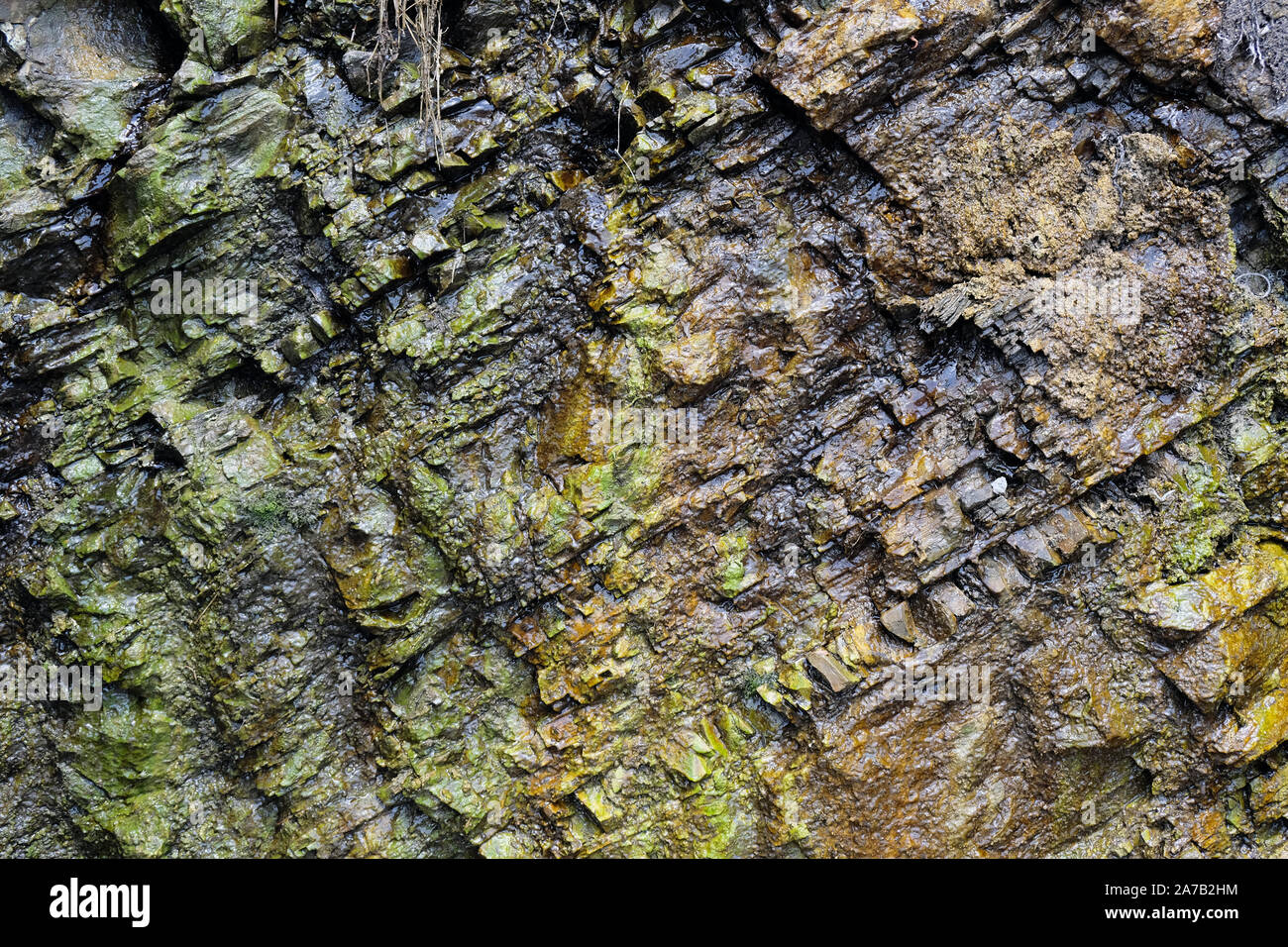 Surface of rocks wall with water flowing. Wet rock wall Stock Photo - Alamy