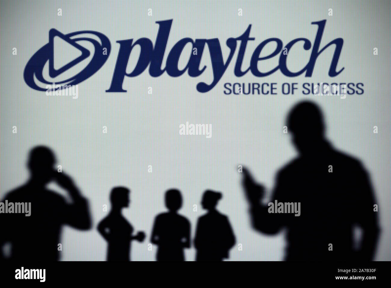 The Playtech logo is seen on an LED screen in the background while a ...