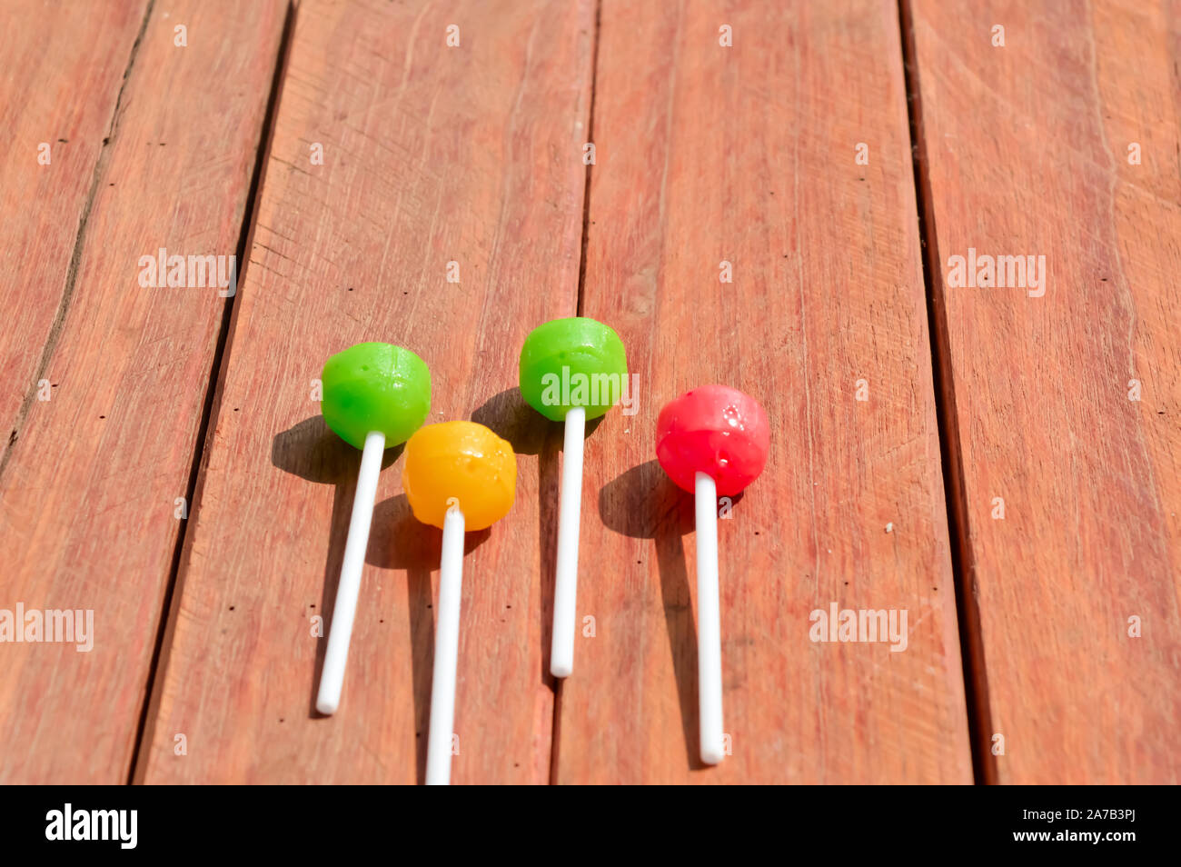 4 lollipop on wooden table,sweet candy concept Stock Photo - Alamy