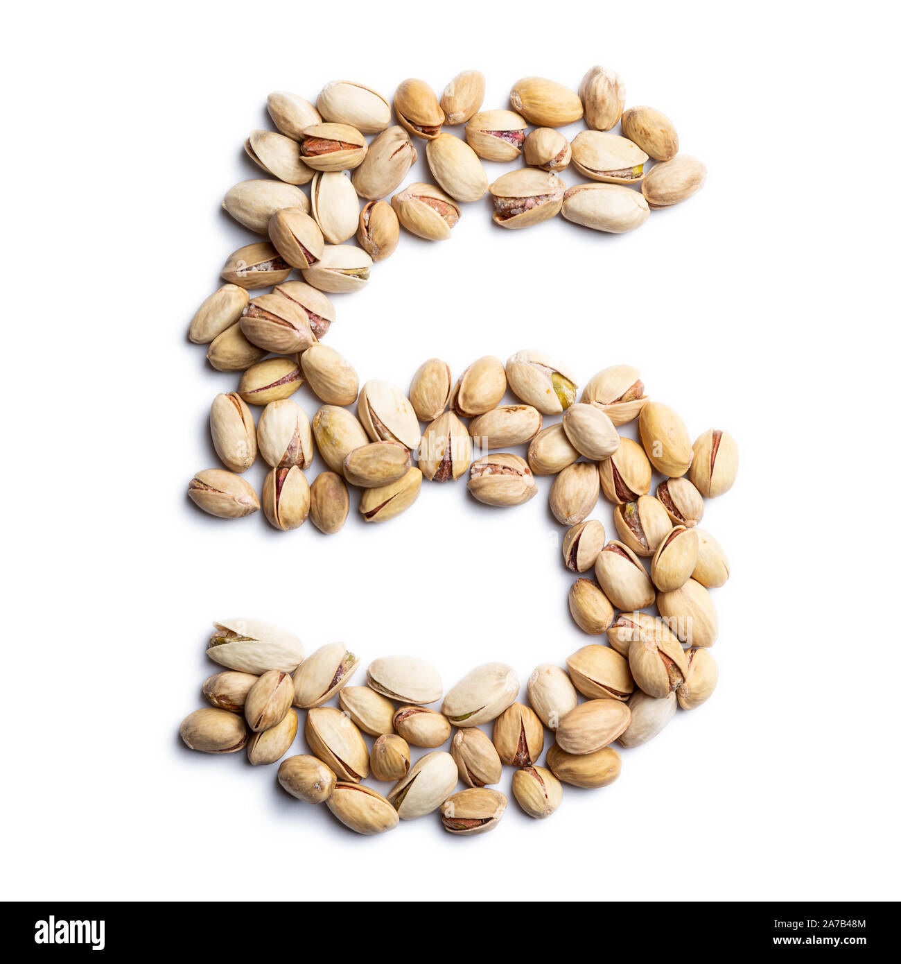 Arabic numeral "5" from an unpeeled pistachios on a white isolated ...