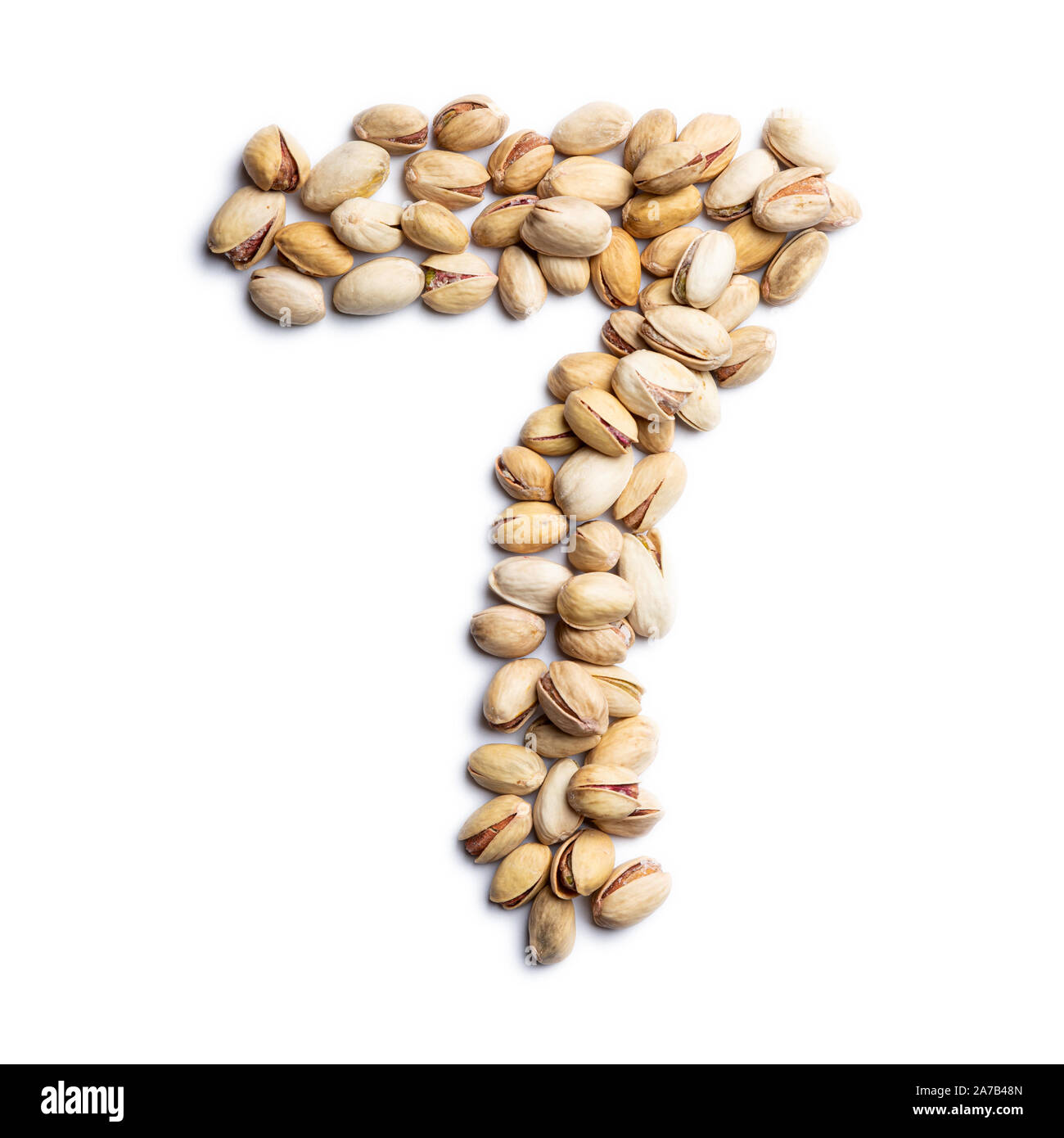 Arabic numeral "7" from an unpeeled pistachios on a white isolated ...