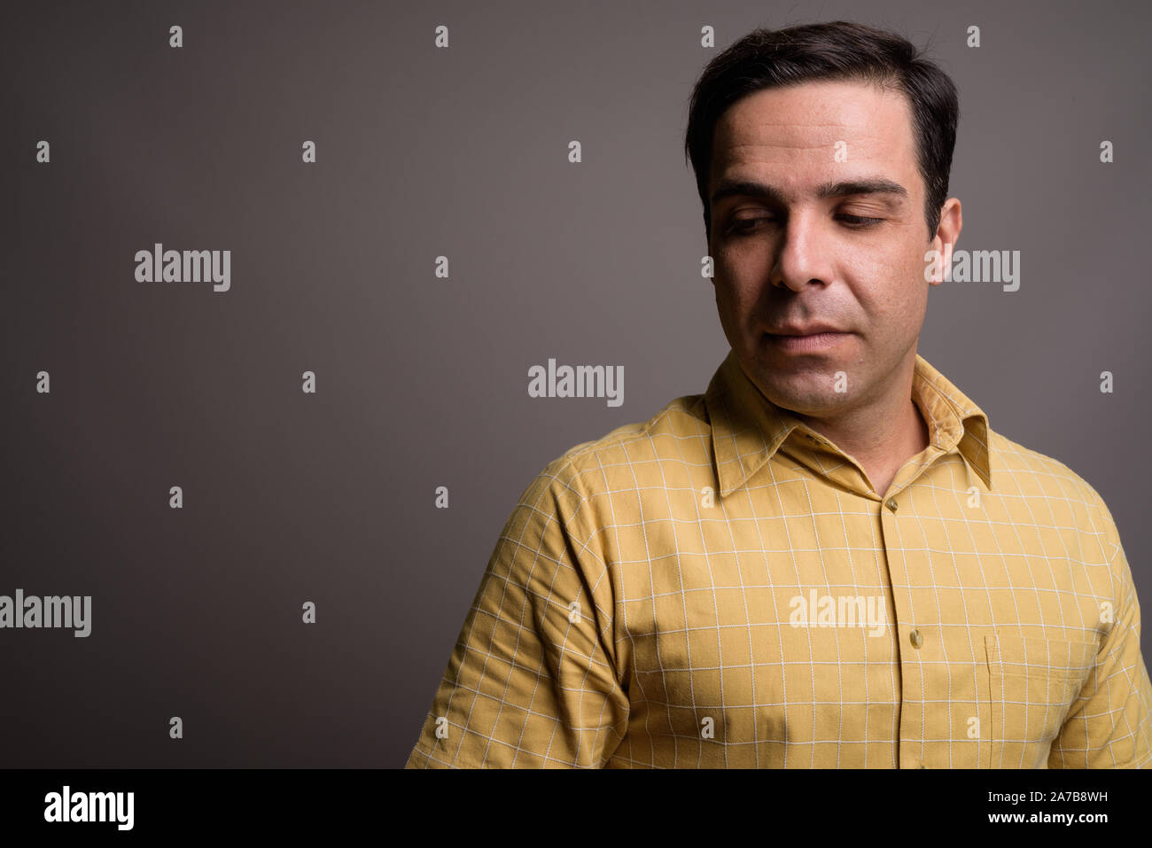 Portrait of handsome Persian man against gray background Stock Photo ...