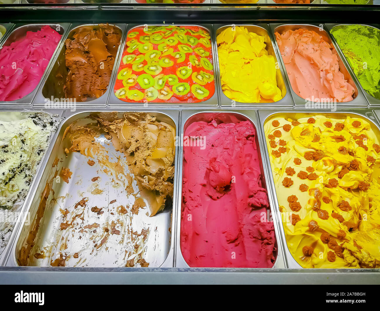 Organic ice cream in frozen metallic trays on metallic surface. Top ...