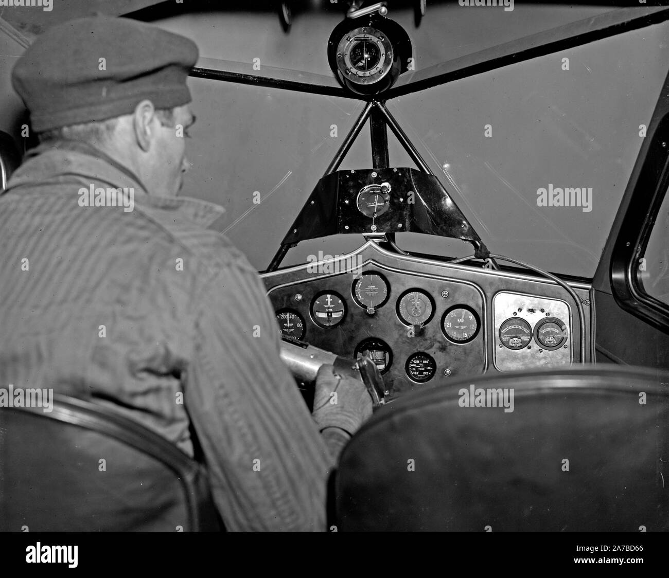 Pilot in a cockpit making a blind landing in a plane ca. 1937 Stock ...