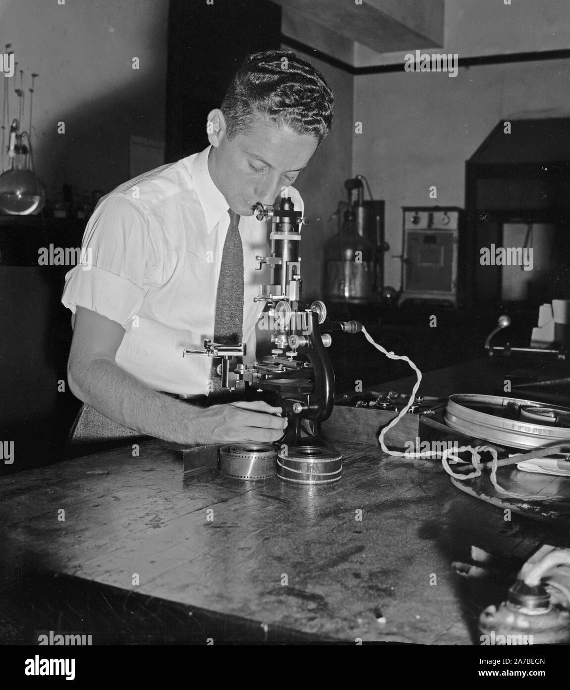 A National Bureau of Standards worker conducting experiement to help ...