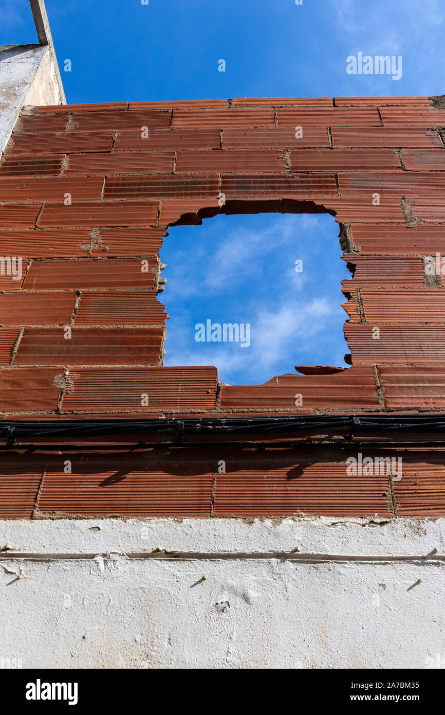 Hole as a window on a brick wall Stock Photo - Alamy