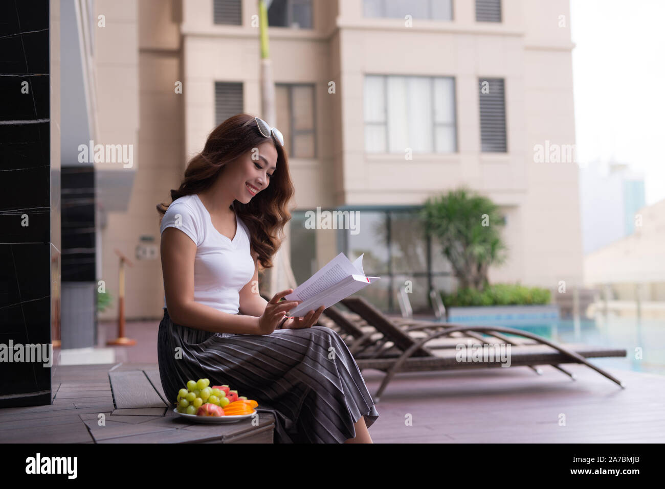 Woman reading book in swimming pool hi-res stock photography and images ...