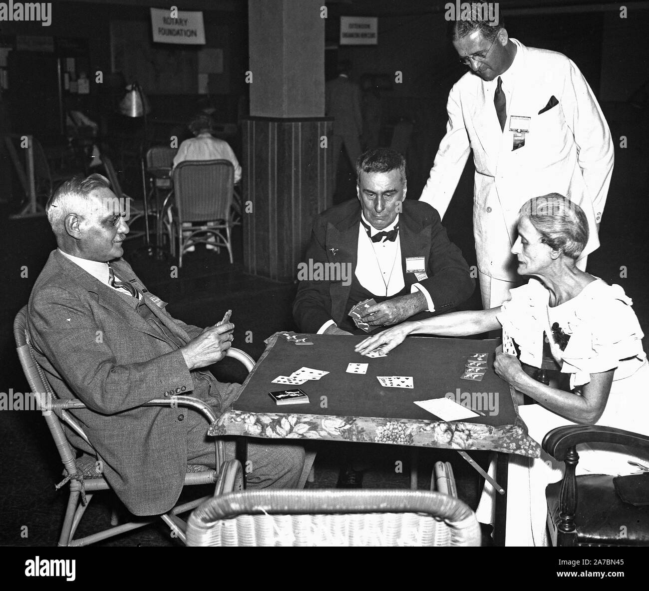 Group of men and and one woman playing cards ca. 1936 Stock Photo - Alamy