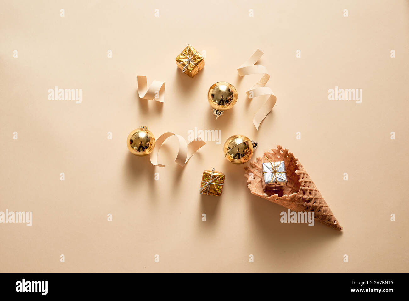 Ice cream waffle cone with ribbon and balls ornament topping. Skin ...