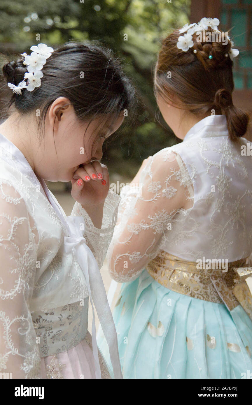 A candid portrait of two young Korean women in traditional Korean ...