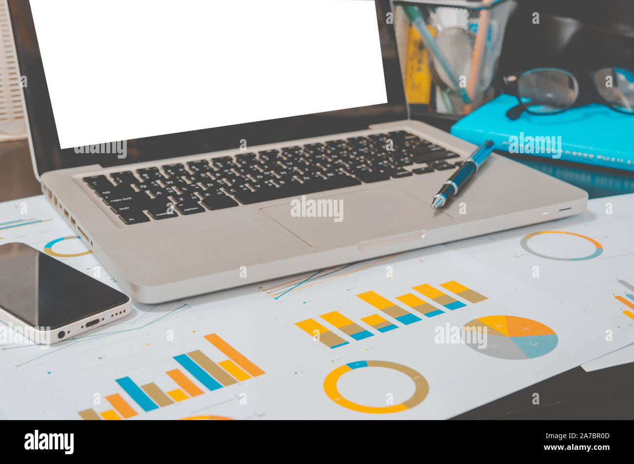 business documents graph financial and computer laptop on table with ...