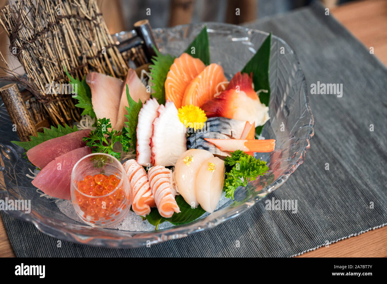 Various japanese fresh sashimi fish and seafood set on ice in glass ...