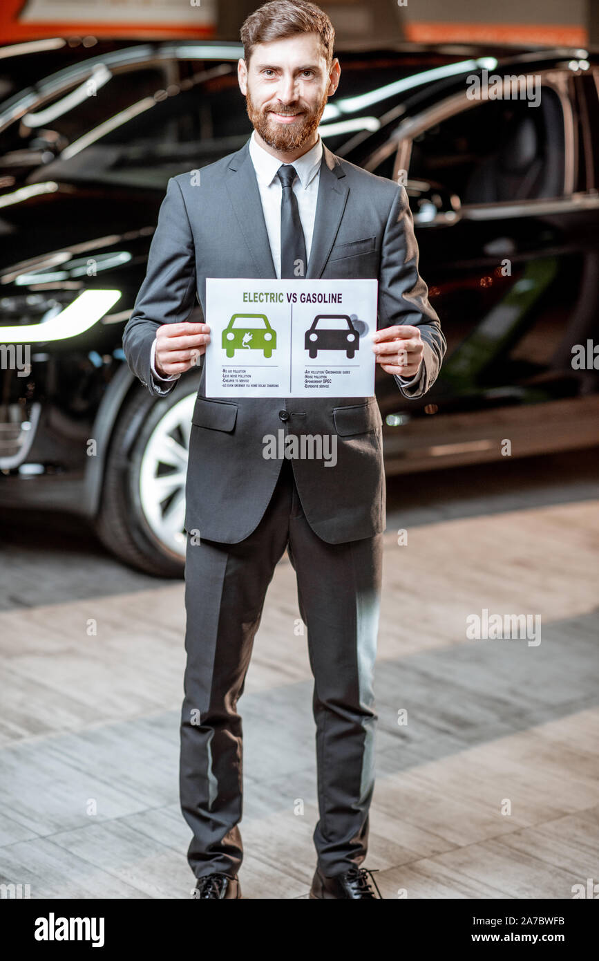 Elegant sales consultant showing a drawing on the topic of eco-friendly ...