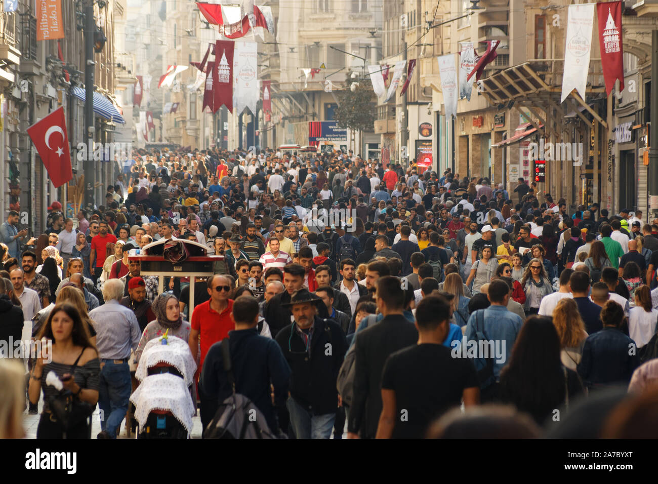 People crowd walking through Istiklal Avenue which is the most famous ...