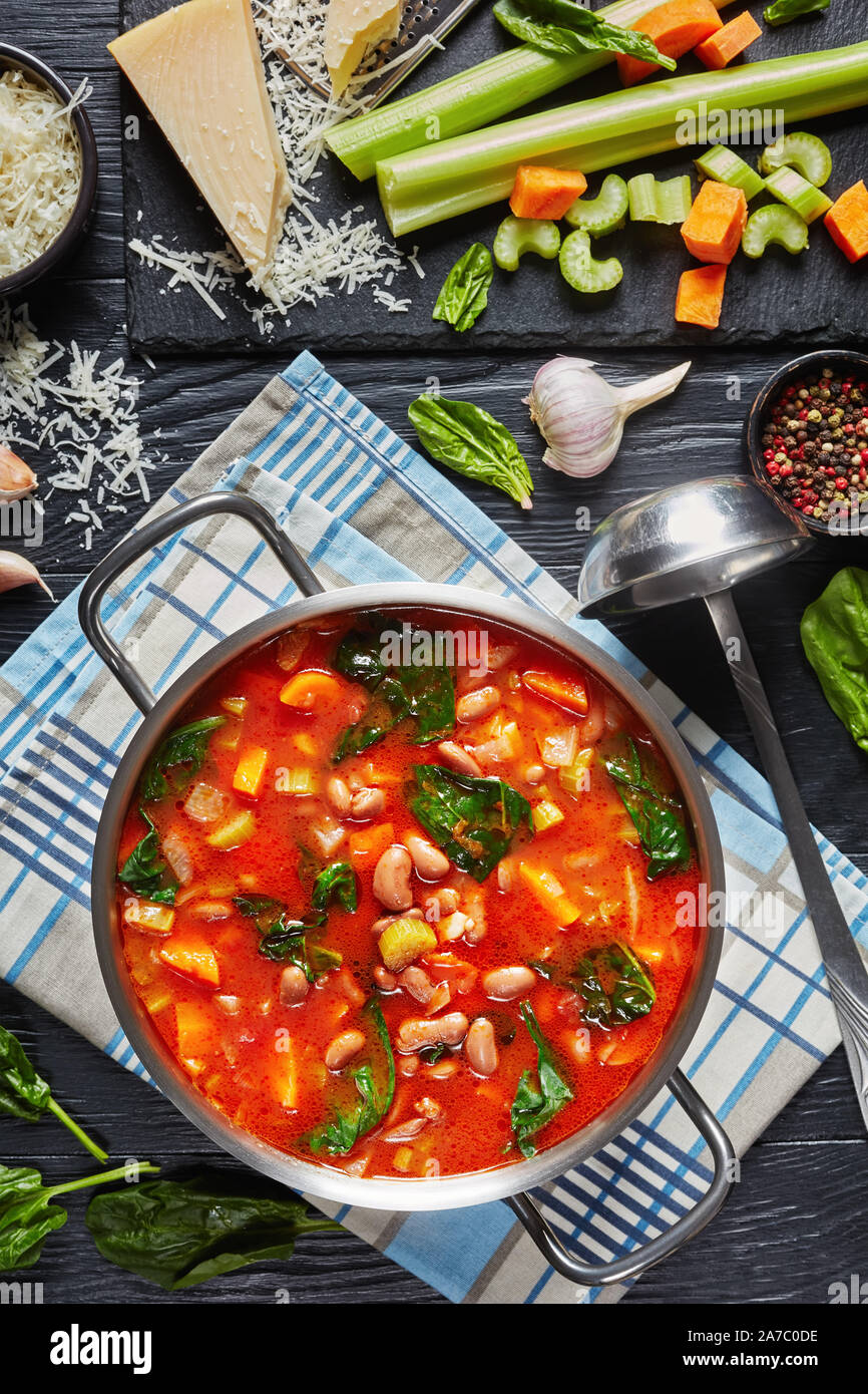 borlotti beans Soup with spinach parmesan and tomato in metal saucepan ...