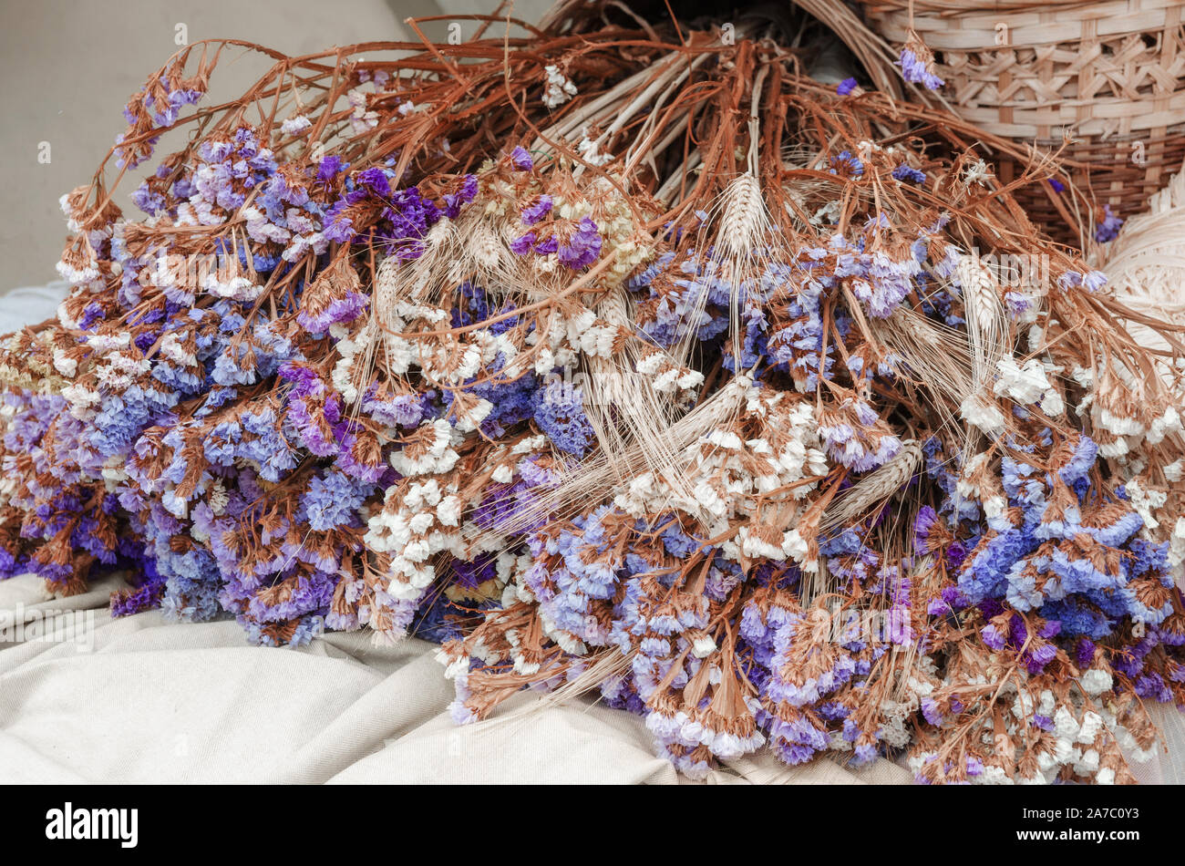 Dried Statice flowers and wheat at countryside at the end of summer ...