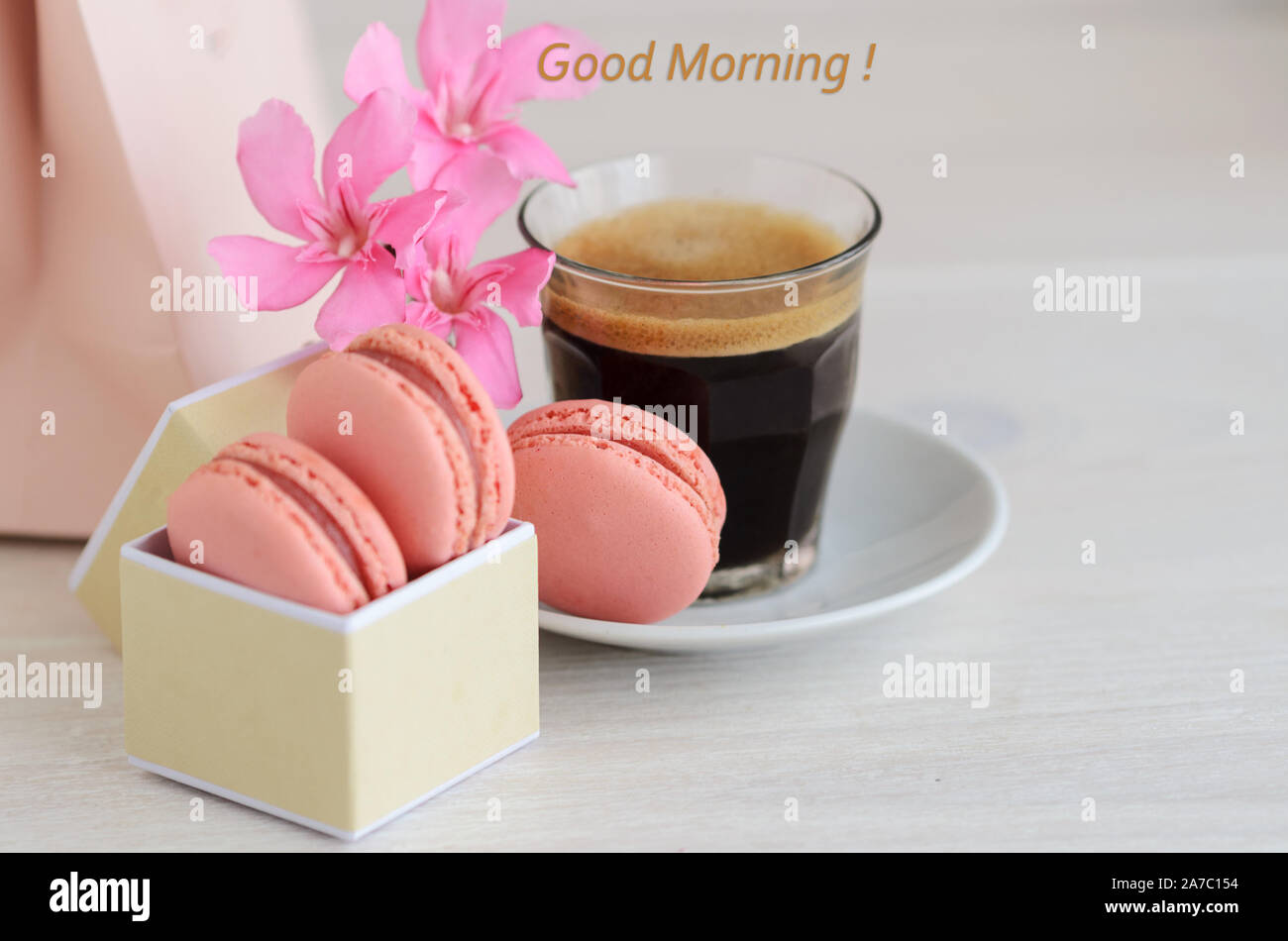 Black coffee and macarons in box with flowers.Good Morning concept.Copy ...