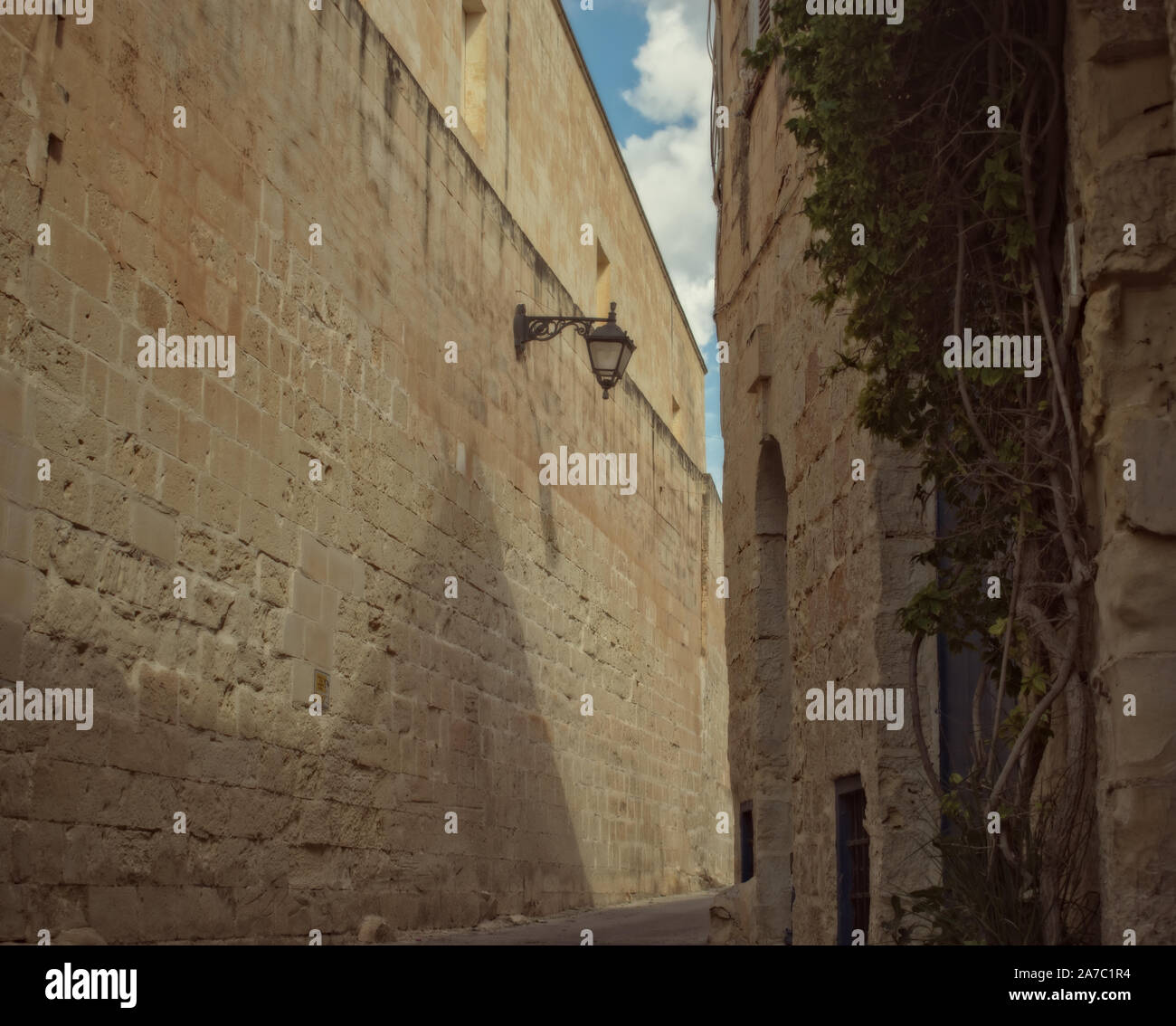Surrounding Walls in Malta. A typical Old Narrow Street with limestone ...
