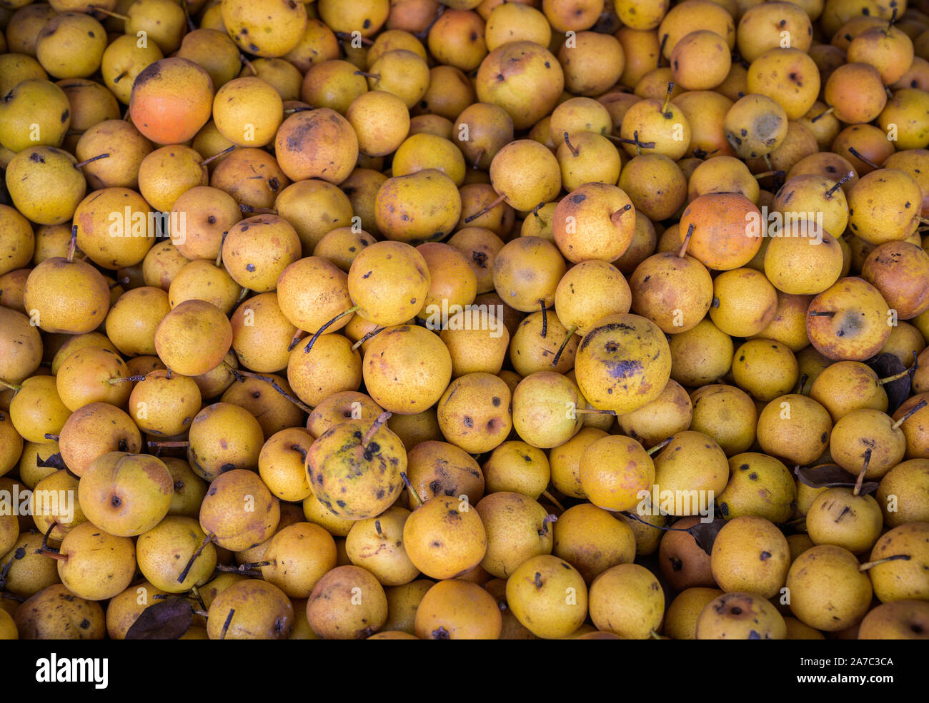 Natural-looking food in a street market - small pears Stock Photo - Alamy