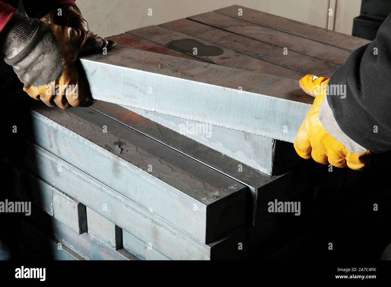 workers and heavy metal blocks Stock Photo - Alamy