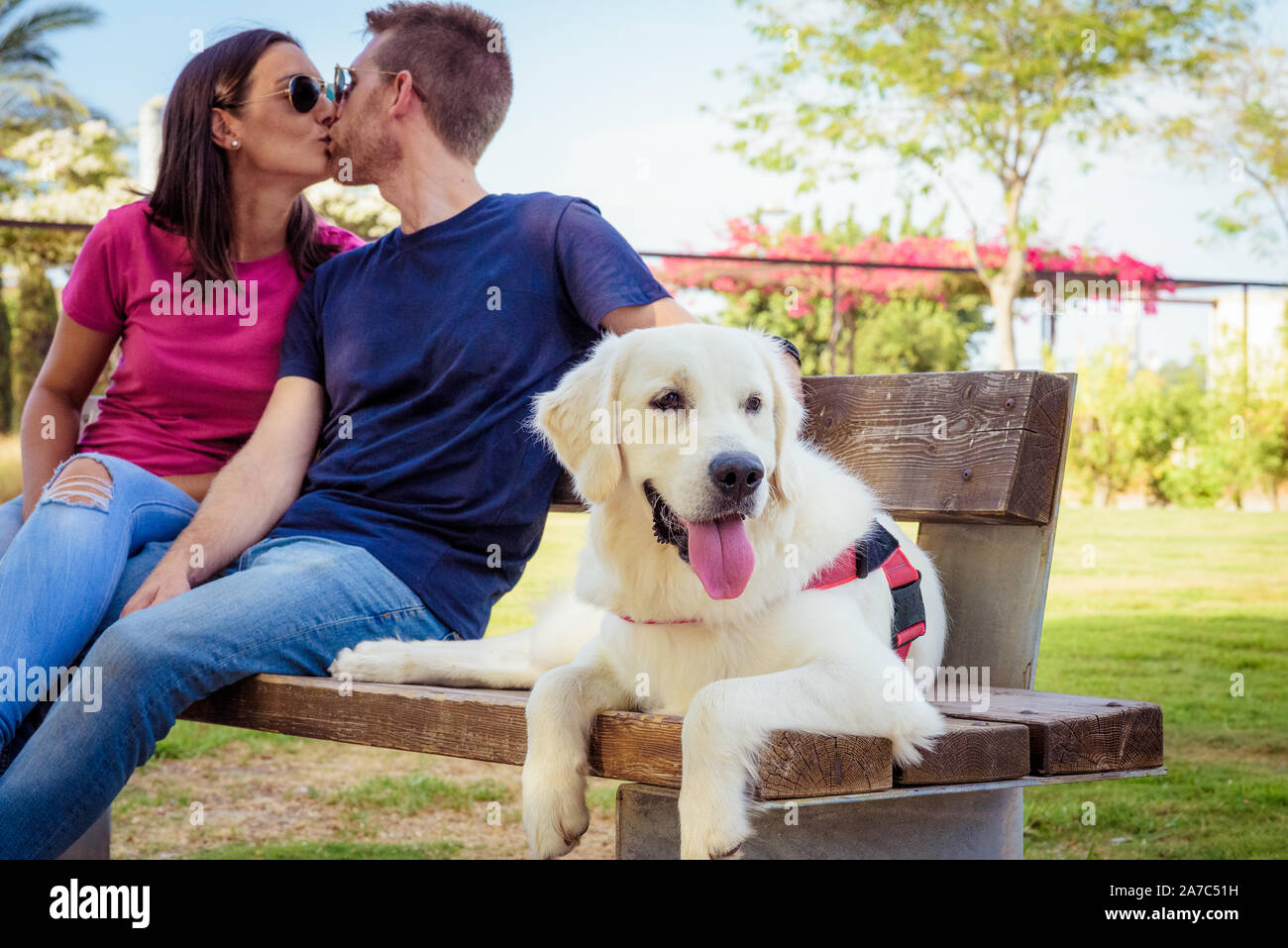 Romantic happy couple in love enjoying their time with pets in nature ...