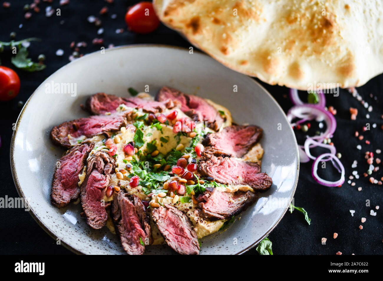lebanese hummus dish with roasted beef & pomegranate seeds Stock Photo ...