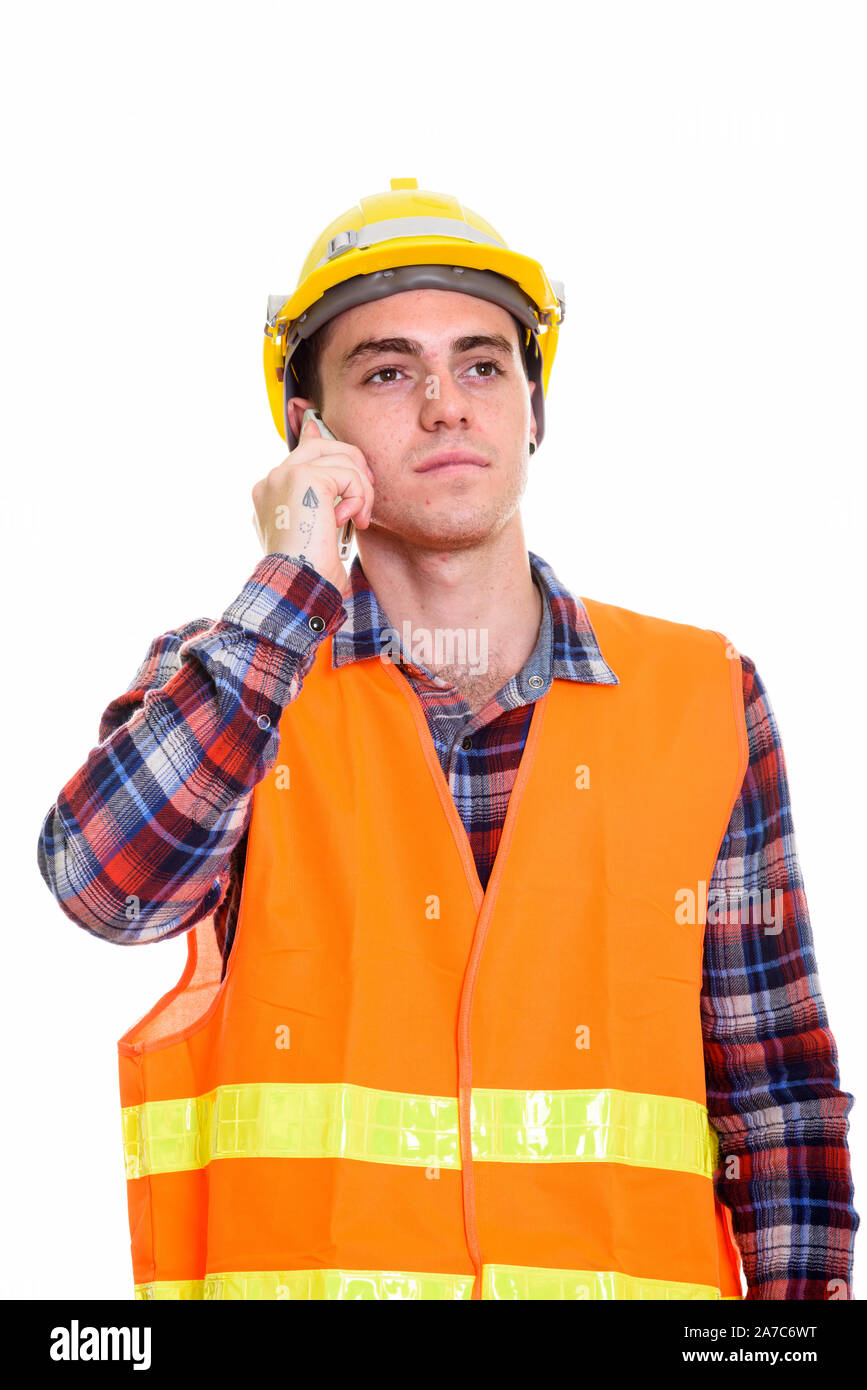 Young man construction worker thinking while talking on the phone Stock ...