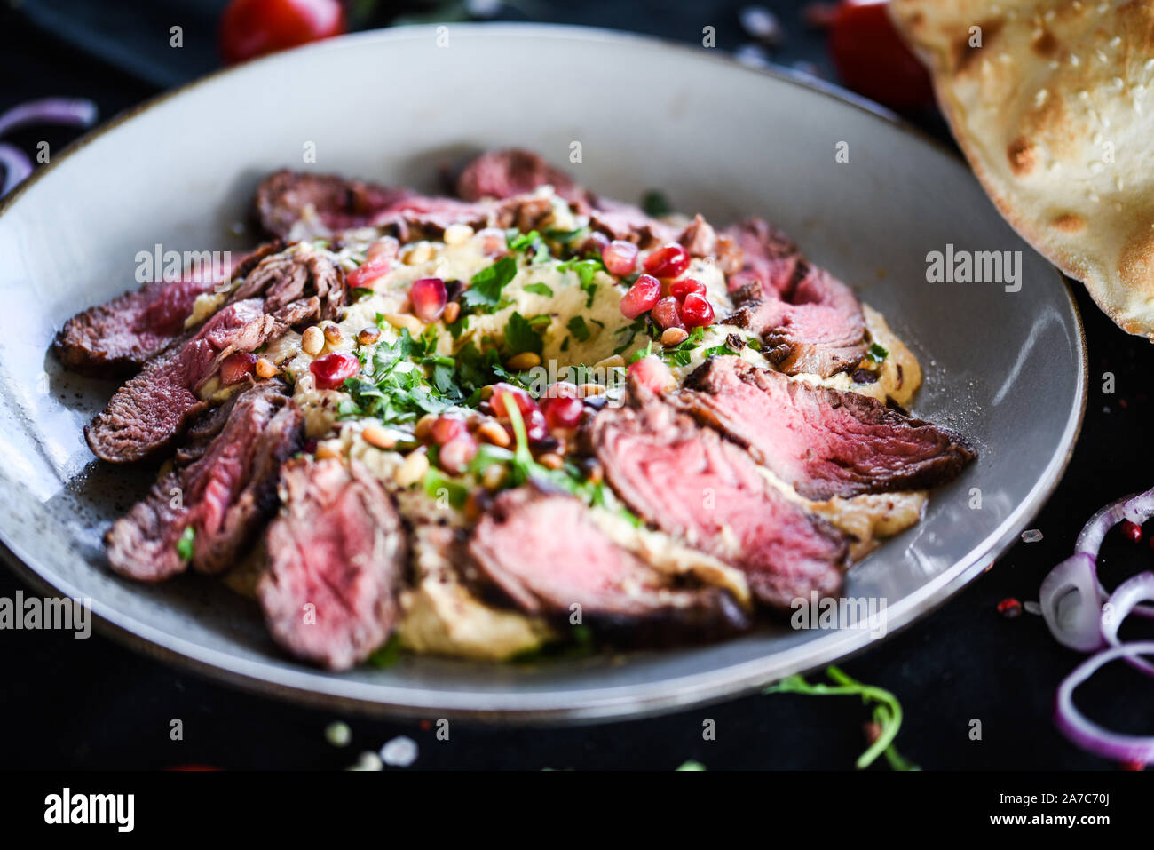 lebanese hummus dish with roasted beef & pomegranate seeds Stock Photo ...