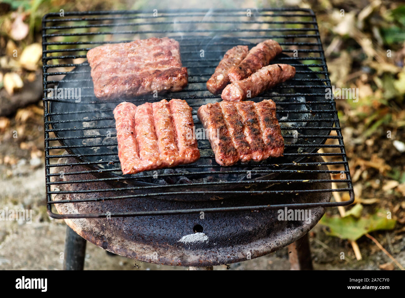 Balkan cuisine Pork Cevapi, grilled minced meat, on the improvised ...