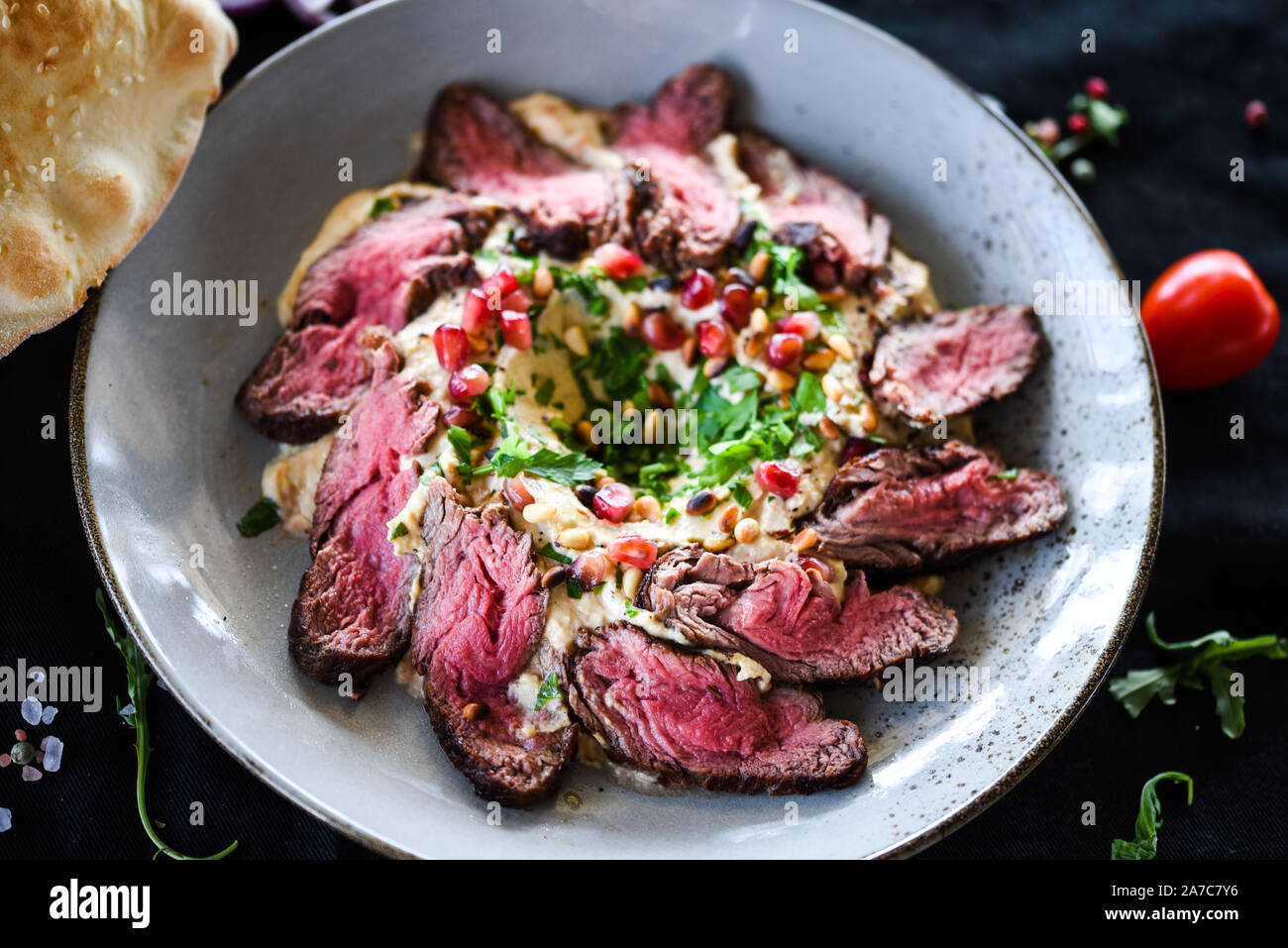 lebanese hummus dish with roasted beef & pomegranate seeds Stock Photo ...