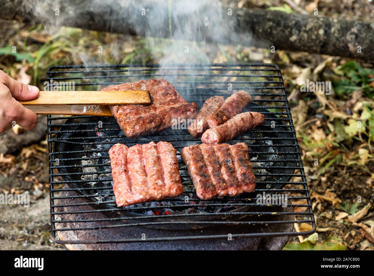 Balkan cuisine Pork Cevapi, grilled minced meat, on the improvised ...