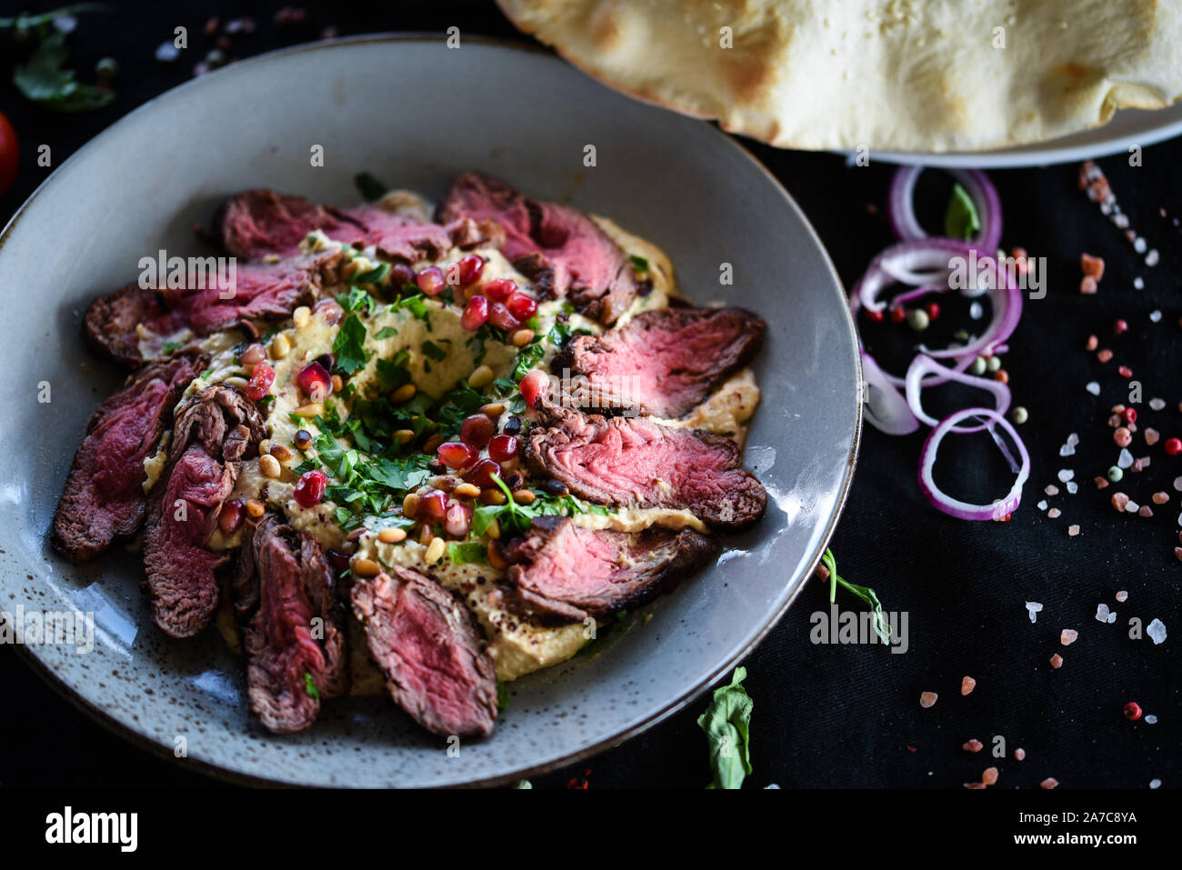 lebanese hummus dish with roasted beef & pomegranate seeds Stock Photo ...