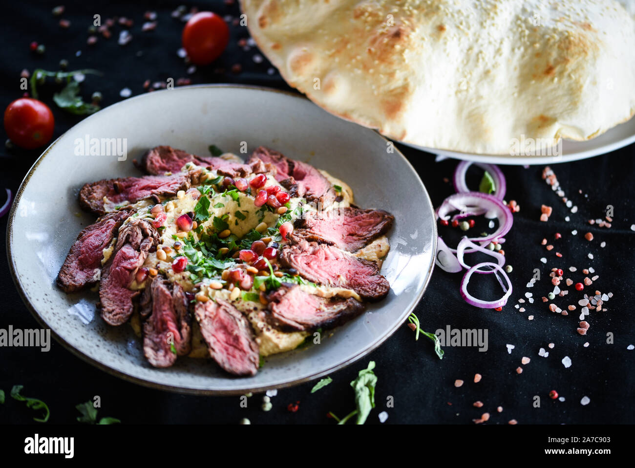 lebanese hummus dish with roasted beef & pomegranate seeds Stock Photo ...