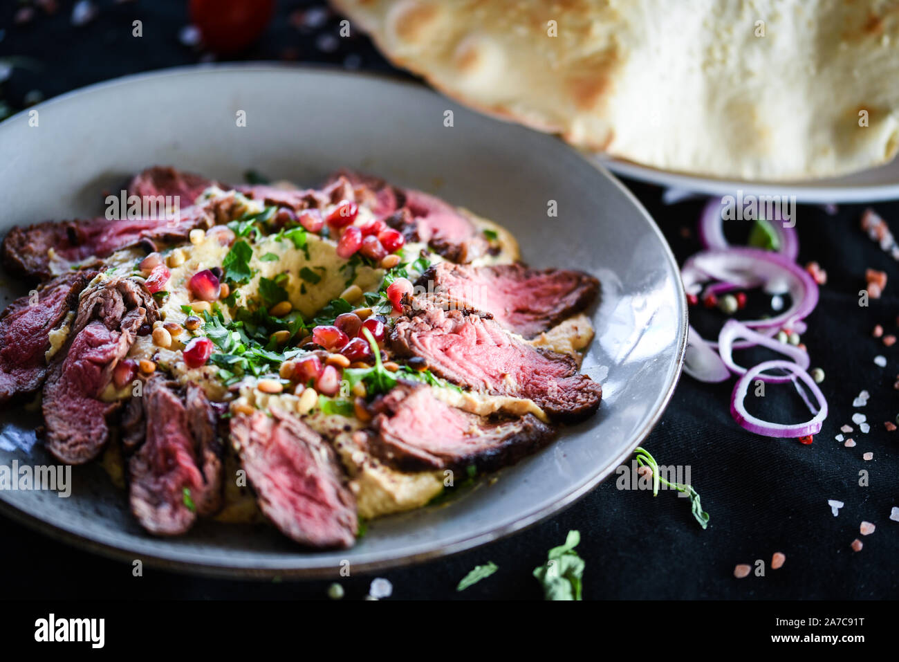 lebanese hummus dish with roasted beef & pomegranate seeds Stock Photo ...