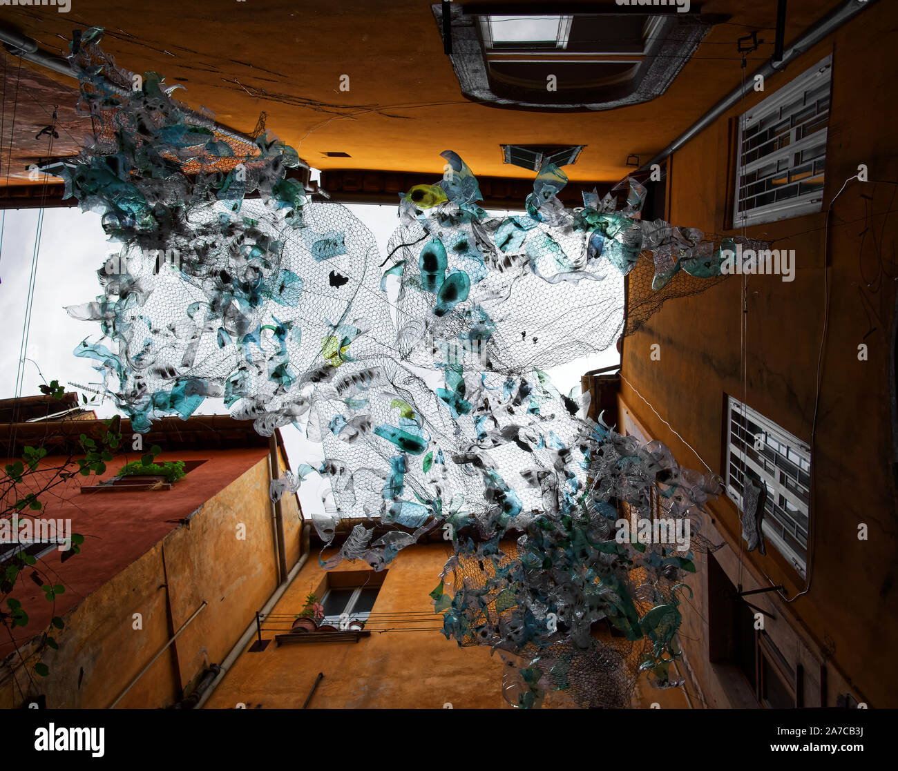 Plastic bottles in a courtyard trapped in a net Stock Photo - Alamy