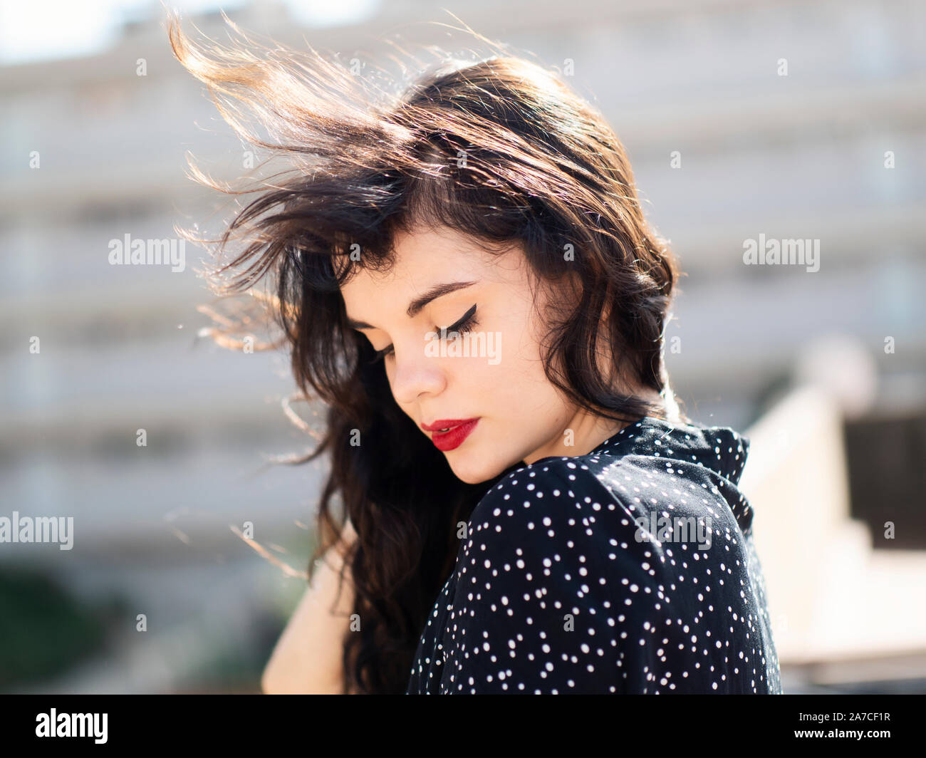 Beautiful young woman outdoors on a windy day with hair flying Stock ...