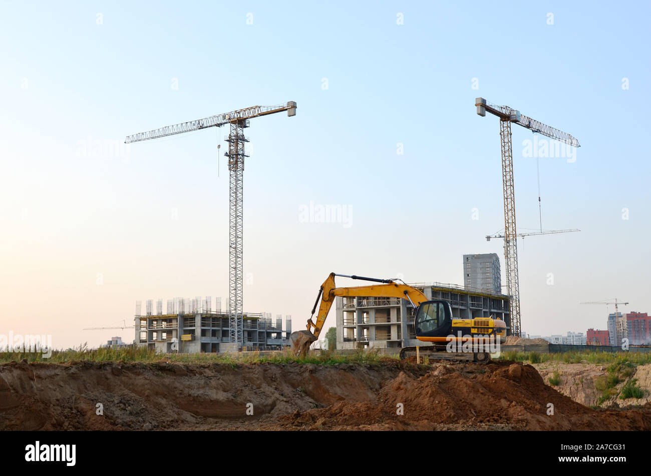 Excavator digs the ground for the foundation and construction of a new ...
