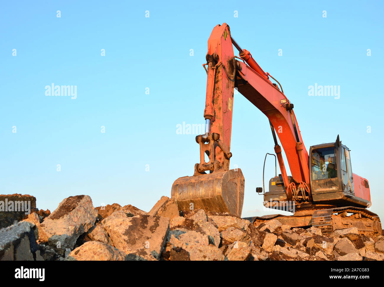 Large tracked excavator works in a gravel pit. Salvaging and recycling ...