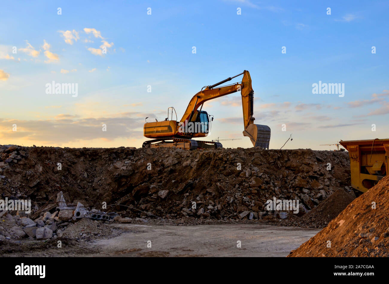 Heavy tracked excavator load stone, old asphalt or concrete waste into ...