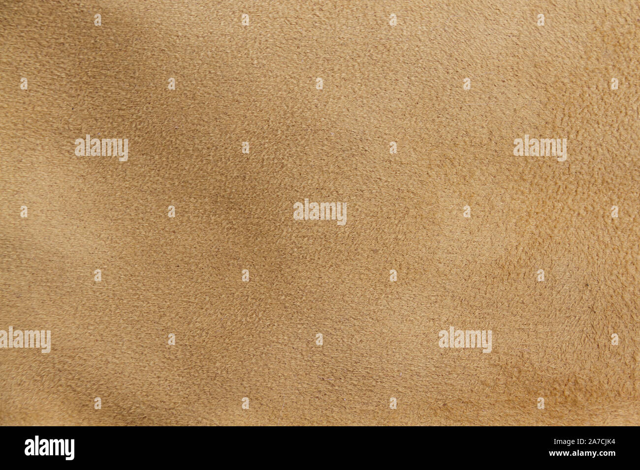 Light brown suede leather texture close up. Useful as a background for ...