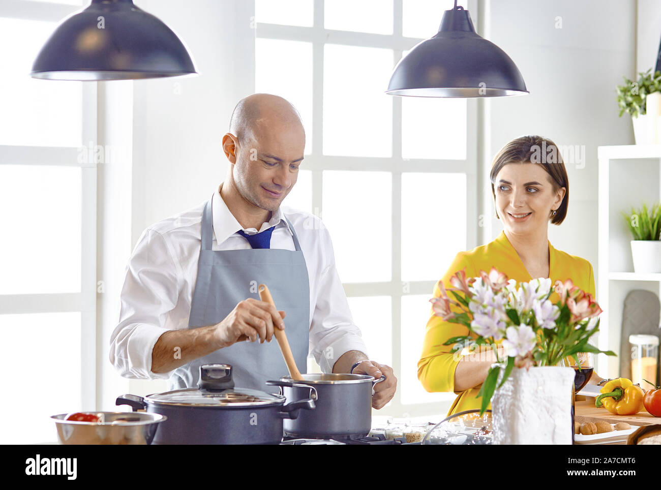Couple cooking together in the kitchen at home Stock Photo - Alamy