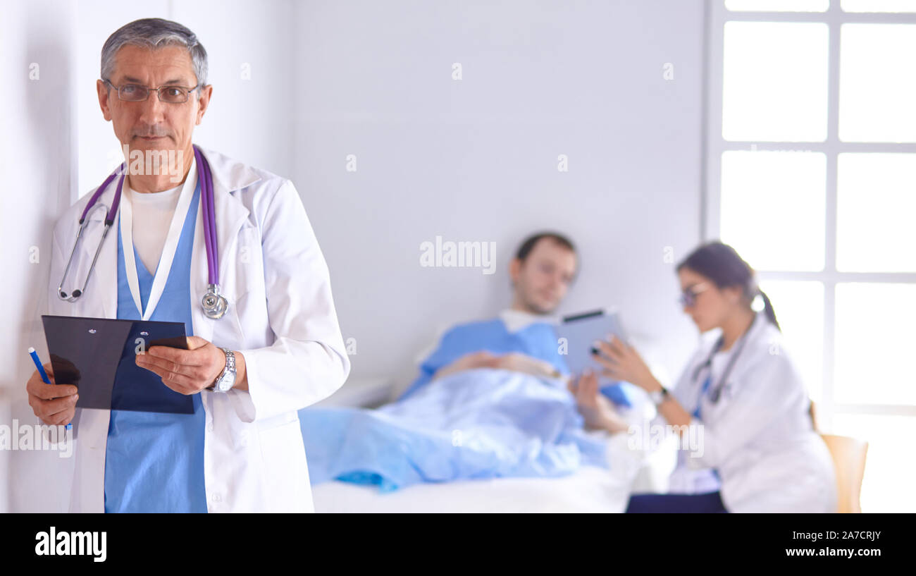 Doctor checking heart beat of patient in bed with stethoscope Stock ...