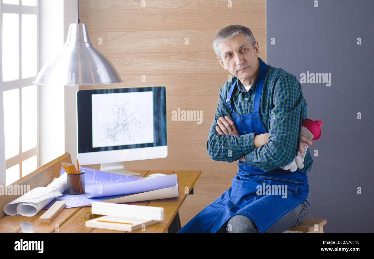 Engineer carpenter working on laptop and sketching project Stock Photo ...