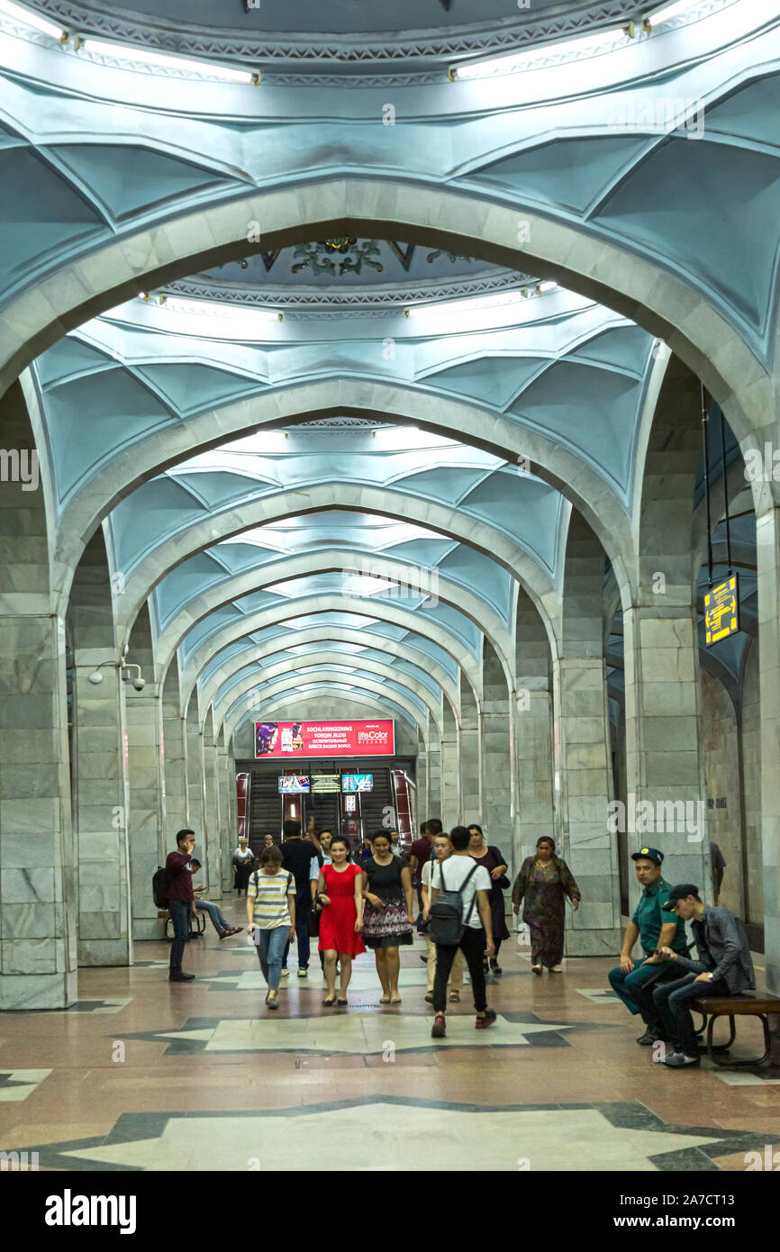 A number of commuters walking down the platform towards me and the exit ...