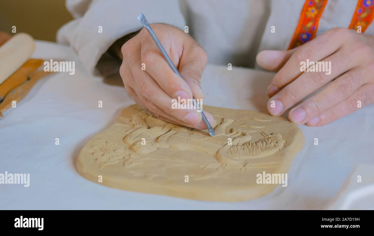 Potter making clay stamp picture Stock Photo - Alamy
