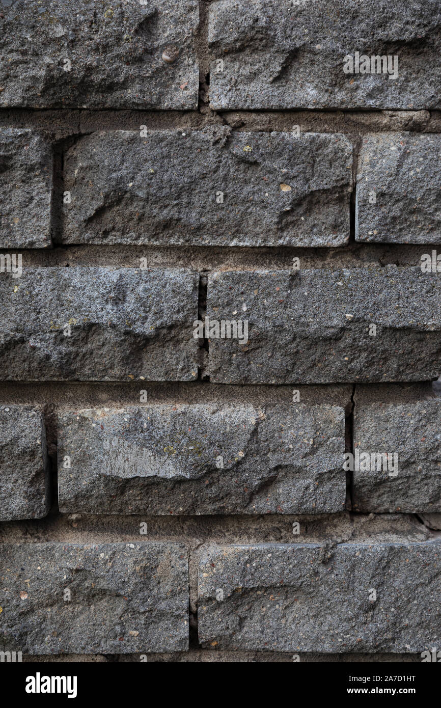Grey wall covered with rough stone tiles Stock Photo - Alamy