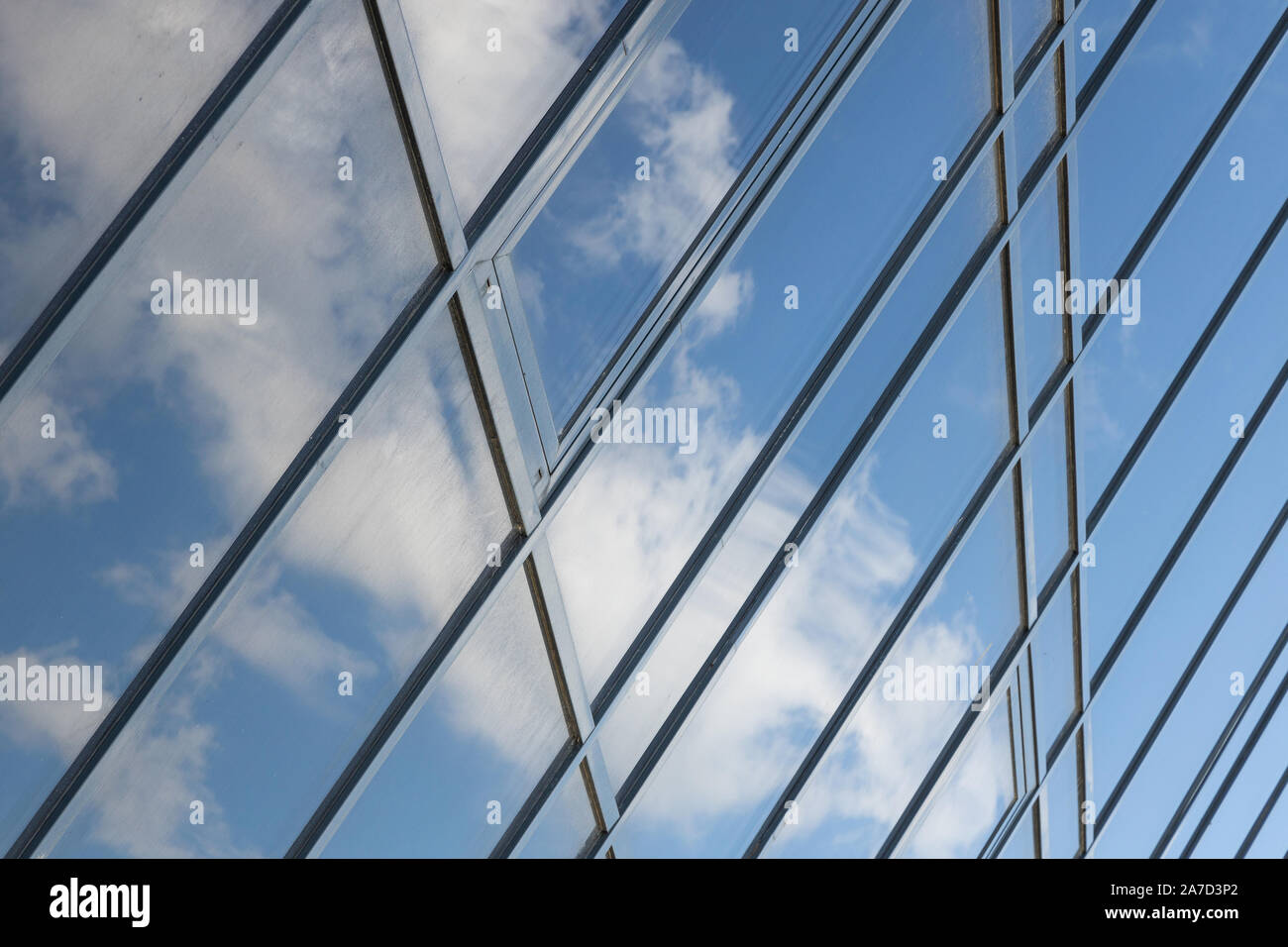 Diagonal view of glass building view with sky reflection, business ...