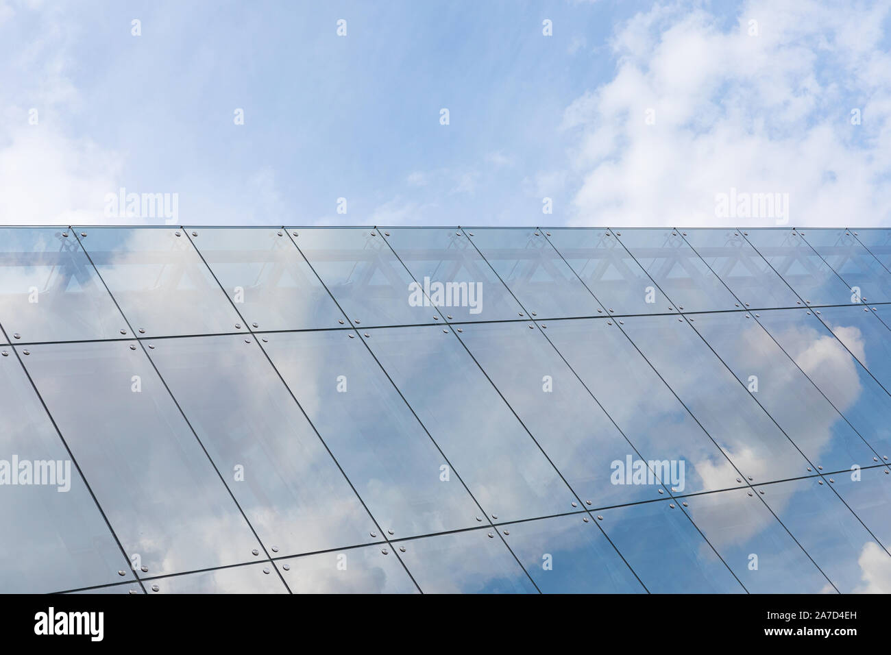 Ascending glass roof of modern building with sky reflection Stock Photo ...