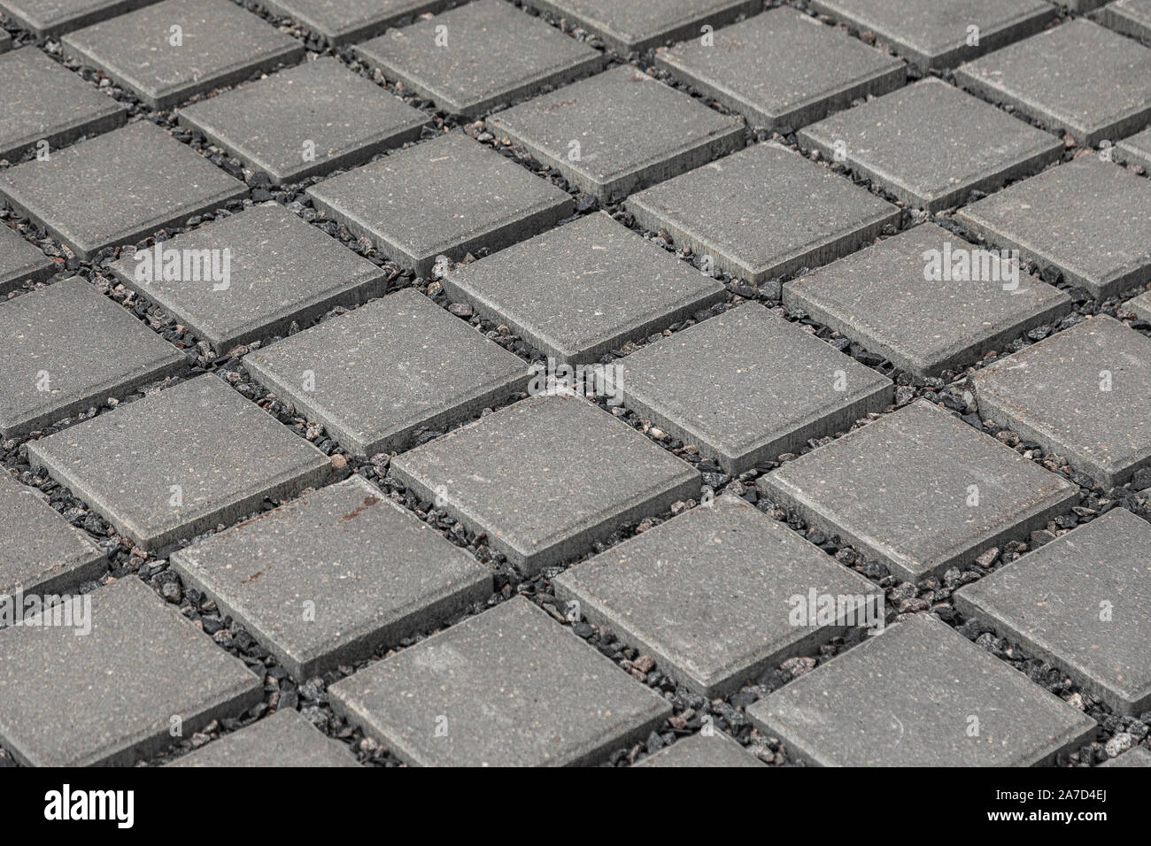 Diagonal view of walkway paved with grey tile Stock Photo - Alamy