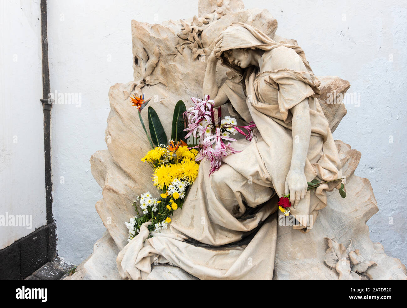 Red rose placed in hand on statue in cemetery Stock Photo - Alamy